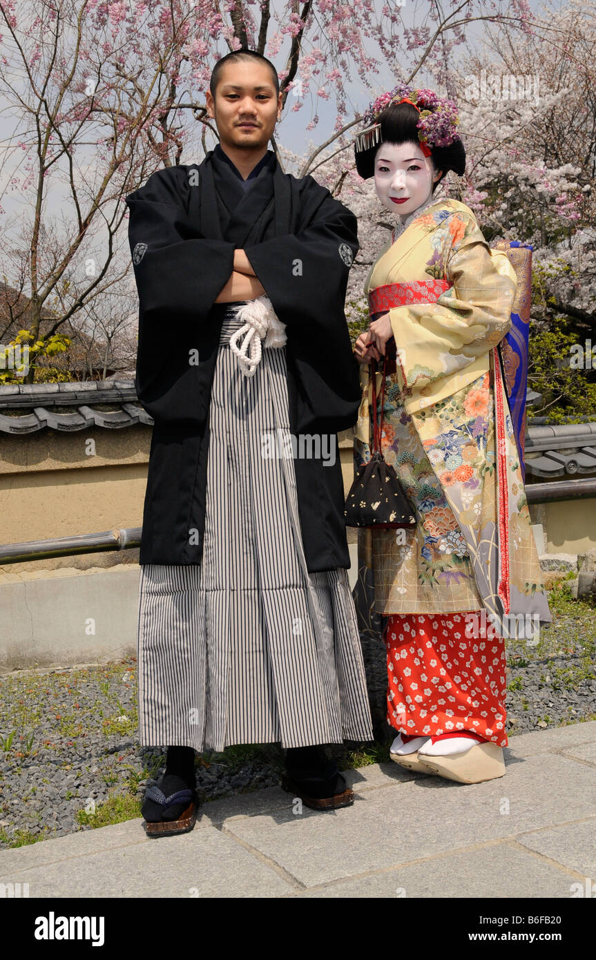 A Maiko, a trainee Geisha, and Japanese man wearing a Kimono, in Stock ...