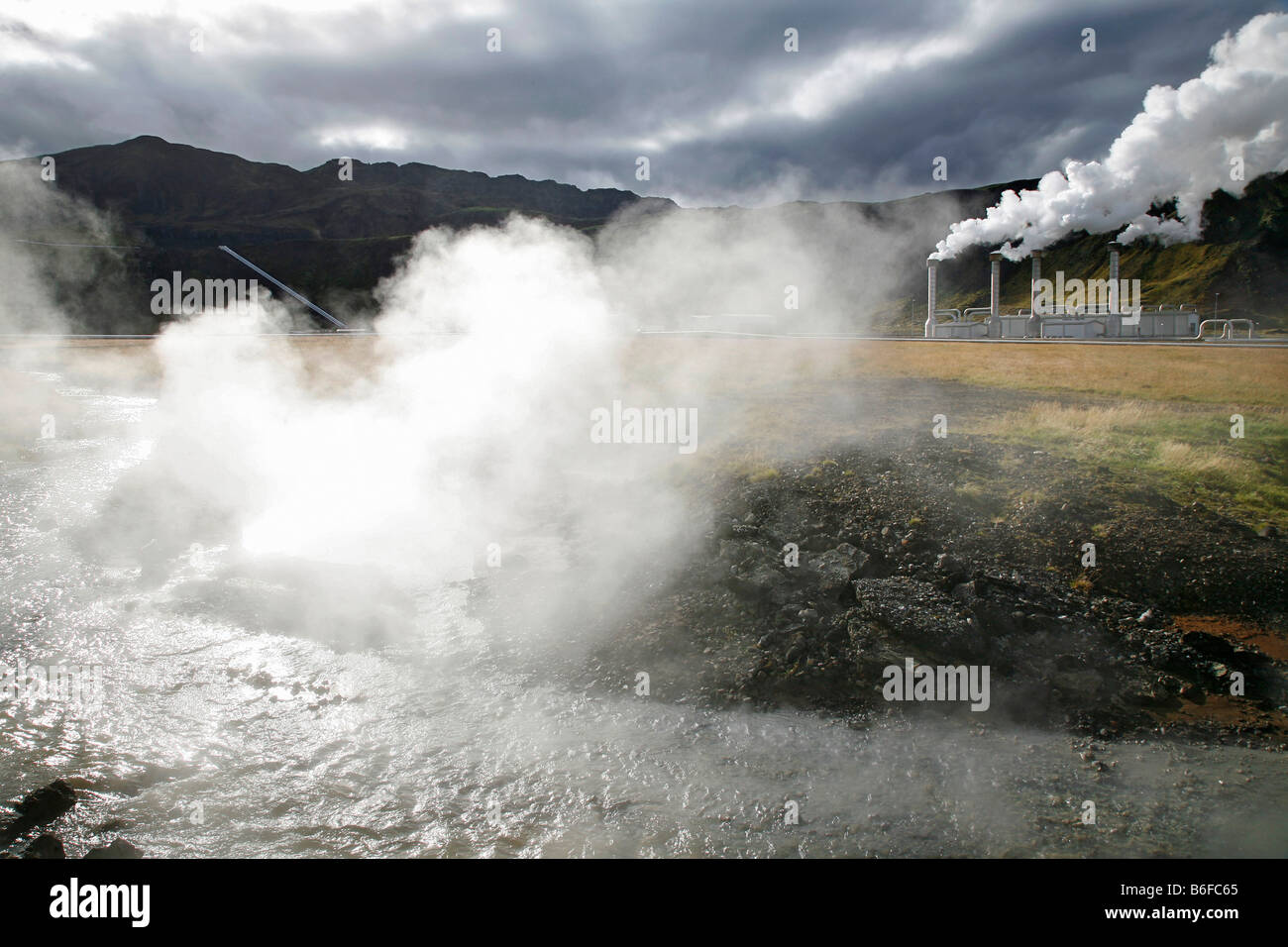 Stream of hot water flowing in front of the geothermal power plant ...