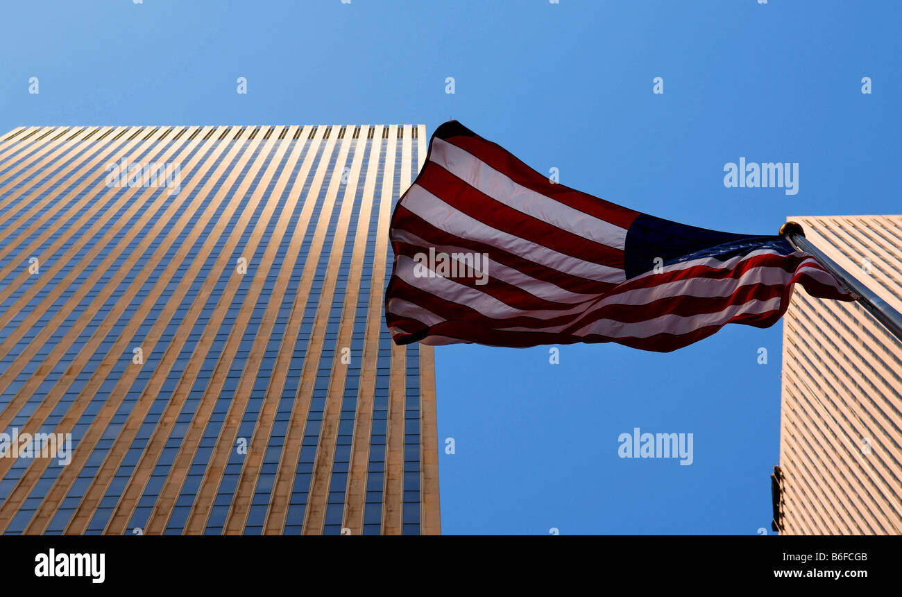 US flag flapping in front of a high-rise skyscraper in New York City ...