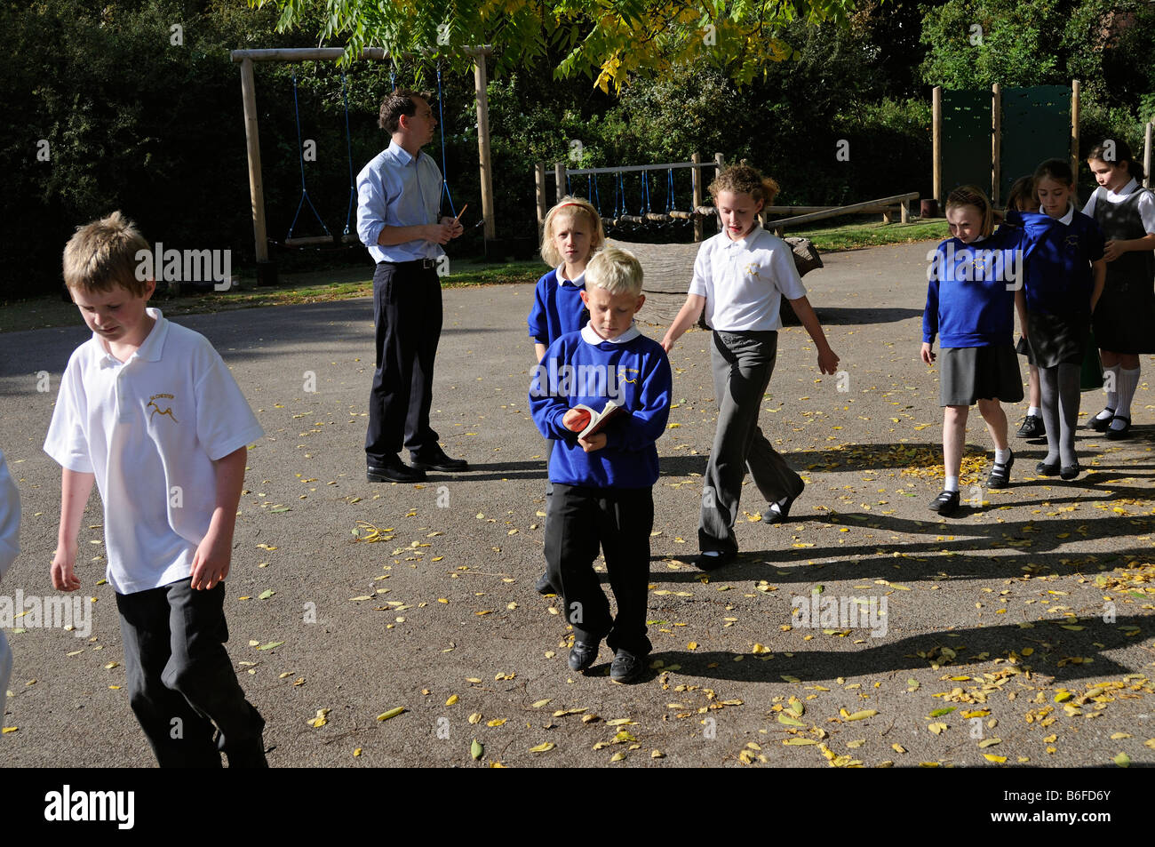 Schoolchildren walking in line in a school playground Stock Photo - Alamy