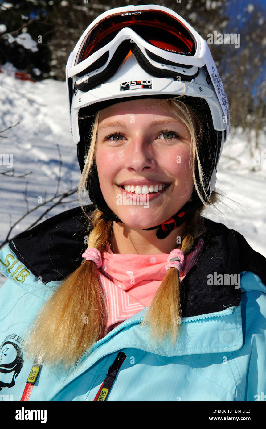 Pretty female skier wearing a helmet Stock Photo - Alamy