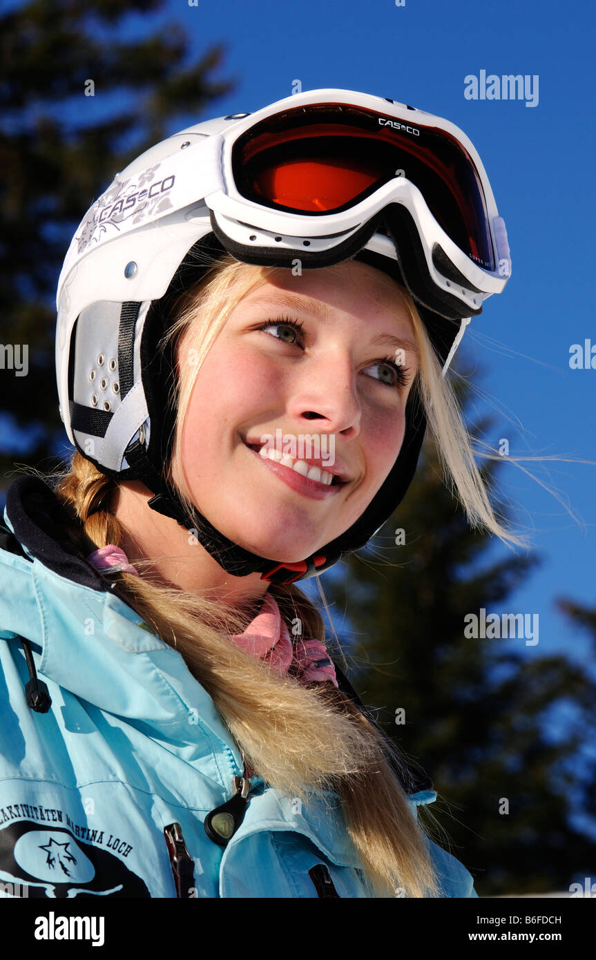 Pretty female skier wearing a helmet Stock Photo - Alamy