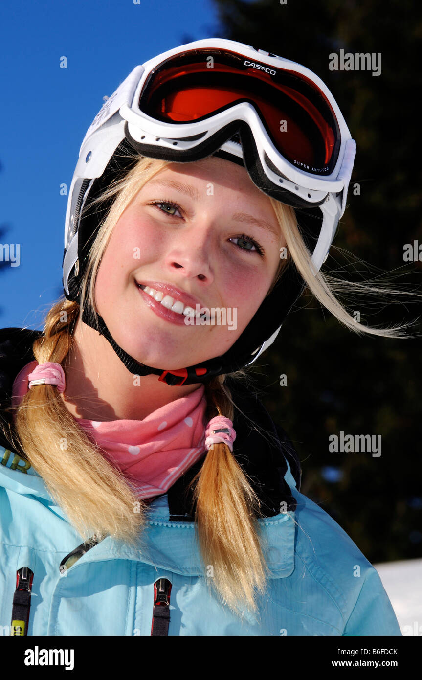 Pretty female skier wearing a helmet Stock Photo - Alamy