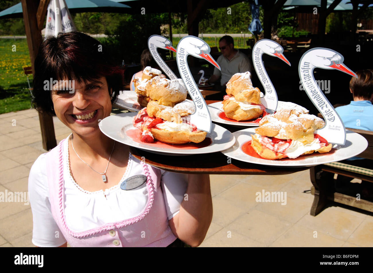 Waitress serving cream puffs, Windbeutelgraefin Cafe, Ruhpolding ...