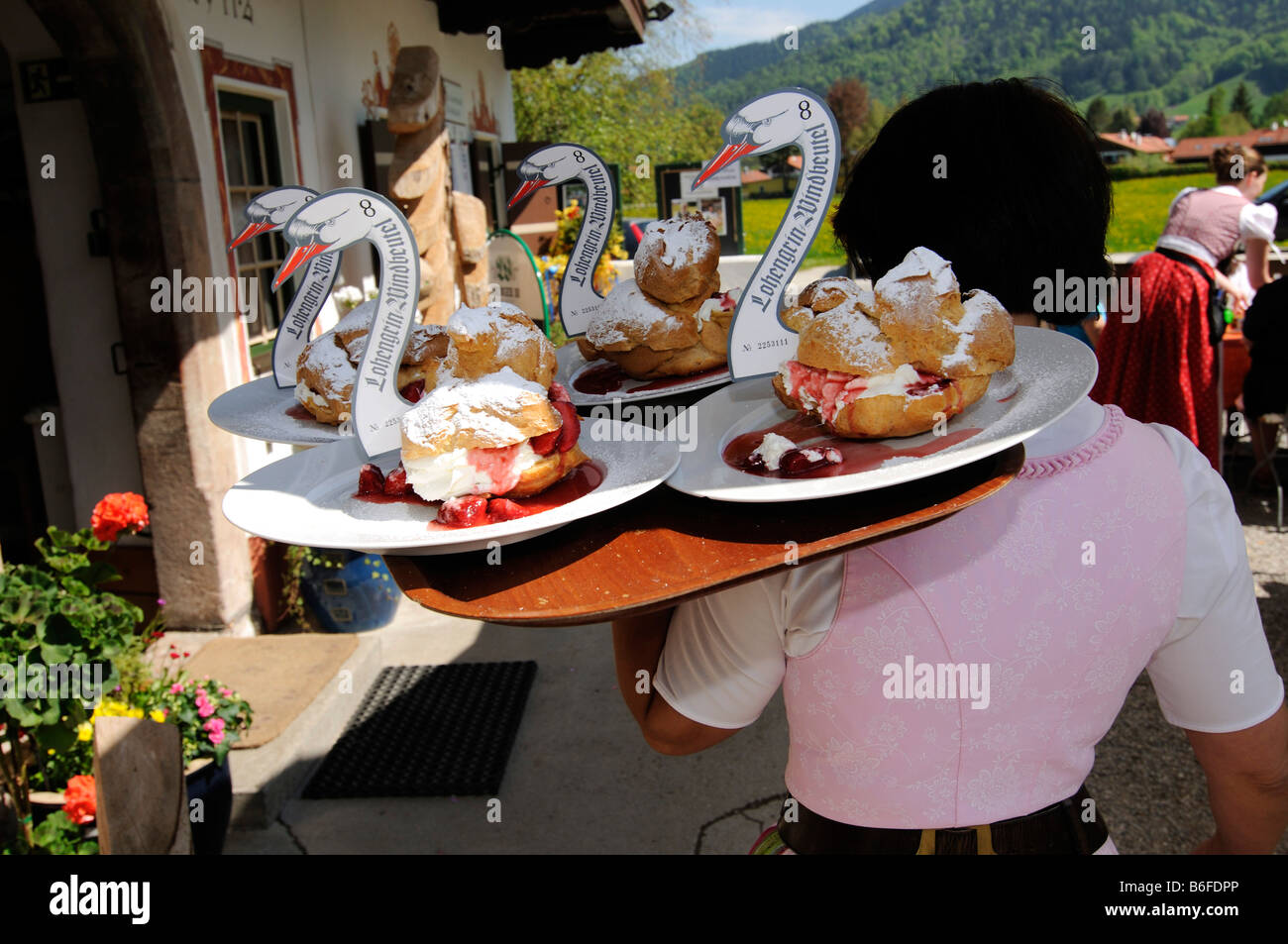 Waitress serving cream puffs, Windbeutelgraefin Cafe, Ruhpolding ...