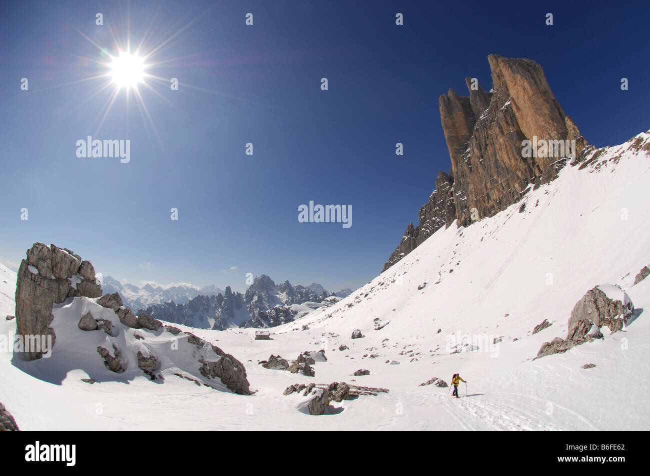 Snowshoe hiker passing the Drei Zinnen or Tre Cime di Lavaredo or Three ...