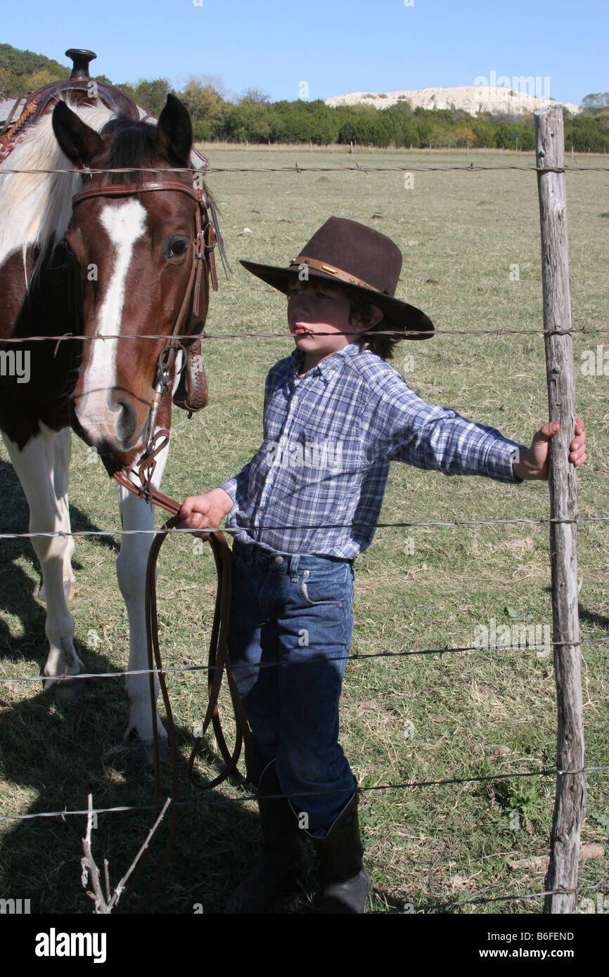 A young cowboy and his horse working on the ranch in Texas Stock Photo ...