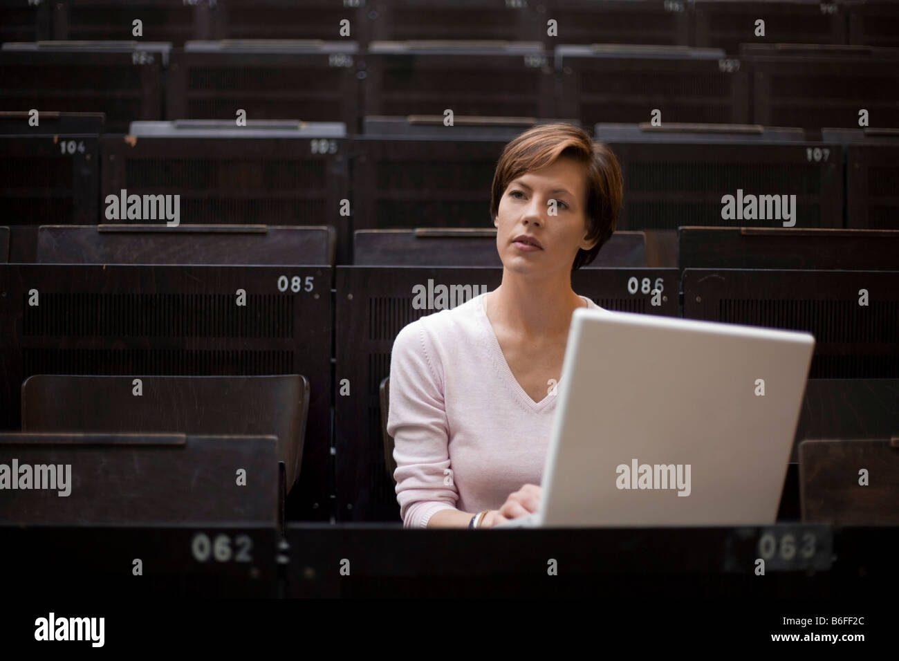 Female student in the lecture hall Stock Photo - Alamy