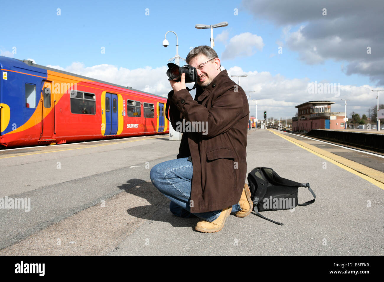Steve, a railways enthusiast, is taking pictures of trains in Wimbledon ...