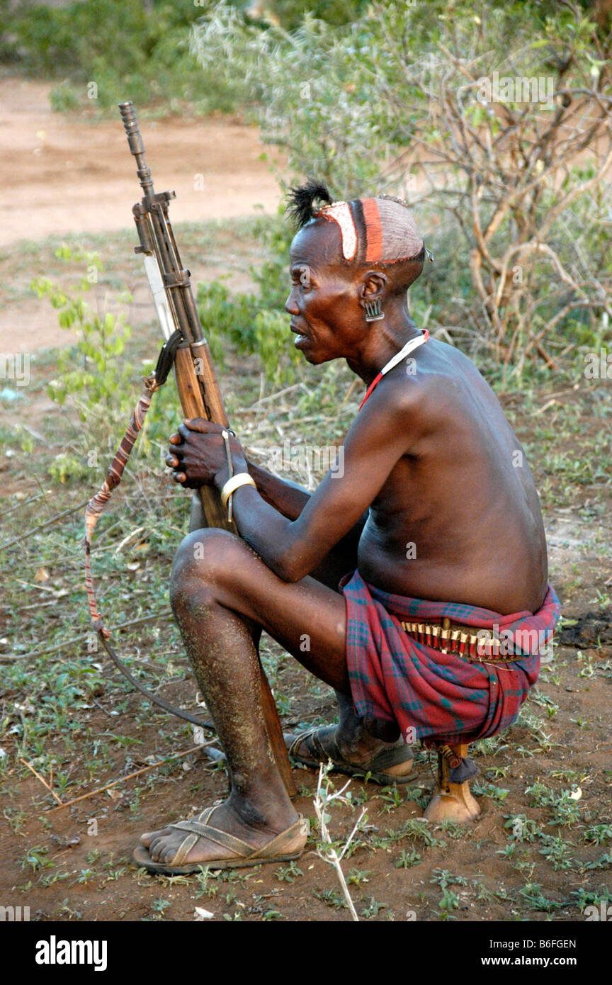 Man with rifle on the lookout, Hamar people, Turmi, Ethiopia, Africa ...