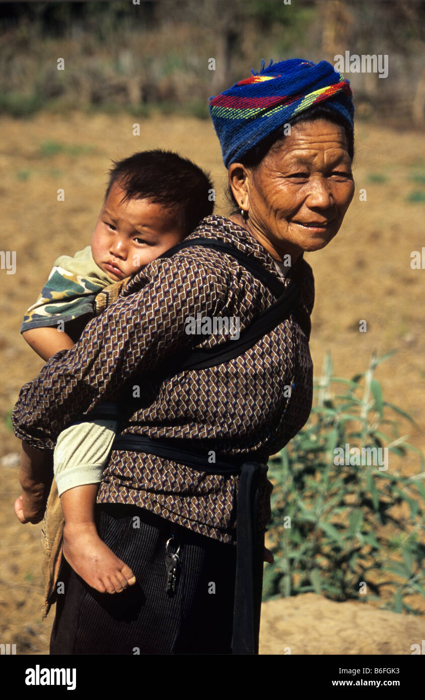 A Hmong woman carries her grandson on her back near Phonsavan, Xieng ...