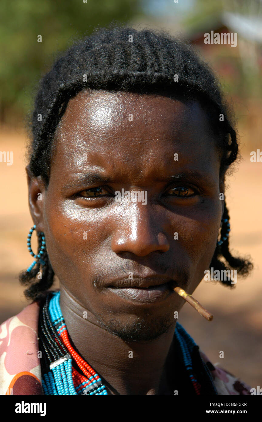 Man chewing on a stick, portrait, at the markets in Dimeka, Ethiopia ...