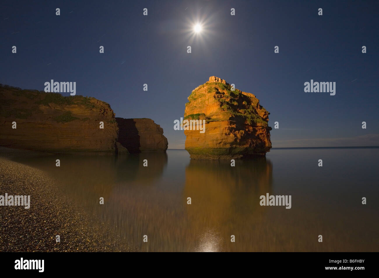 Moonrise over Sea Stack floodlit at night in Ladram Bay Jurassic Coast ...