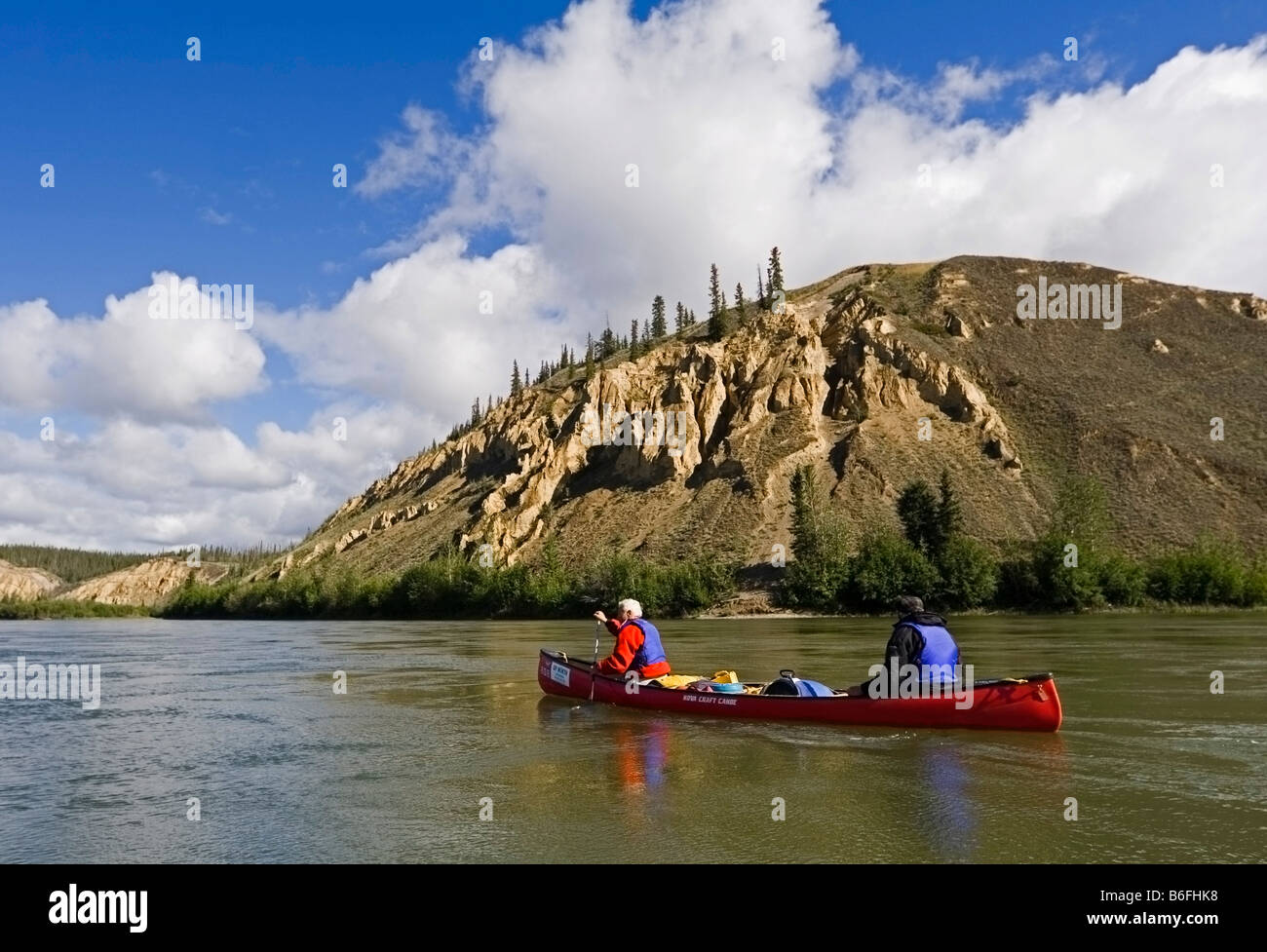 Canoeists on the Yukon River, bluff behind, Yukon Territory, Canada ...