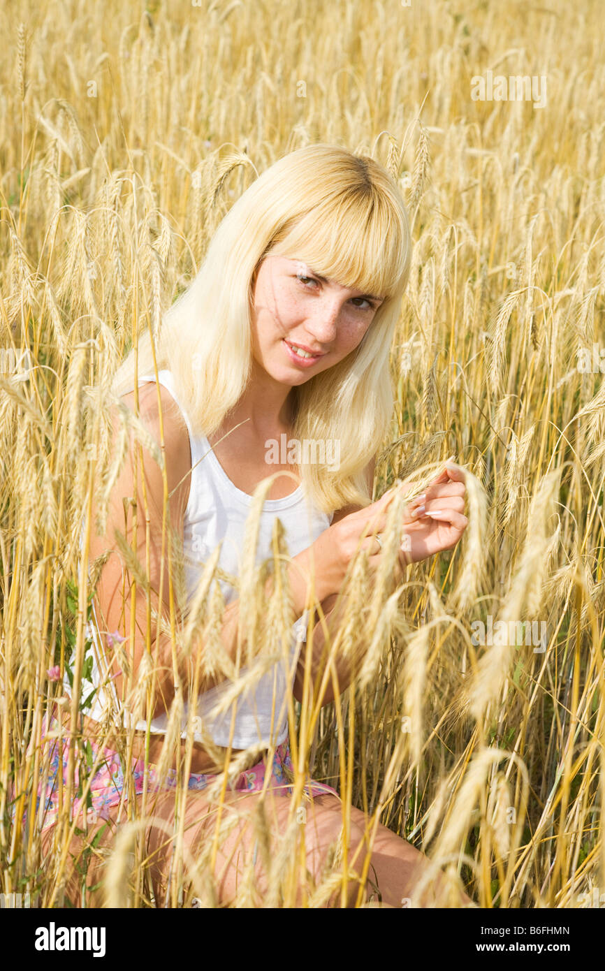 Young woman in the rye meadow Stock Photo - Alamy