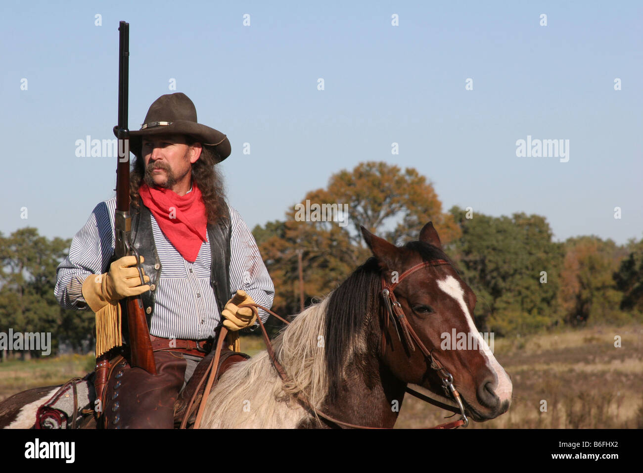 Cowboy On Horse With Gun