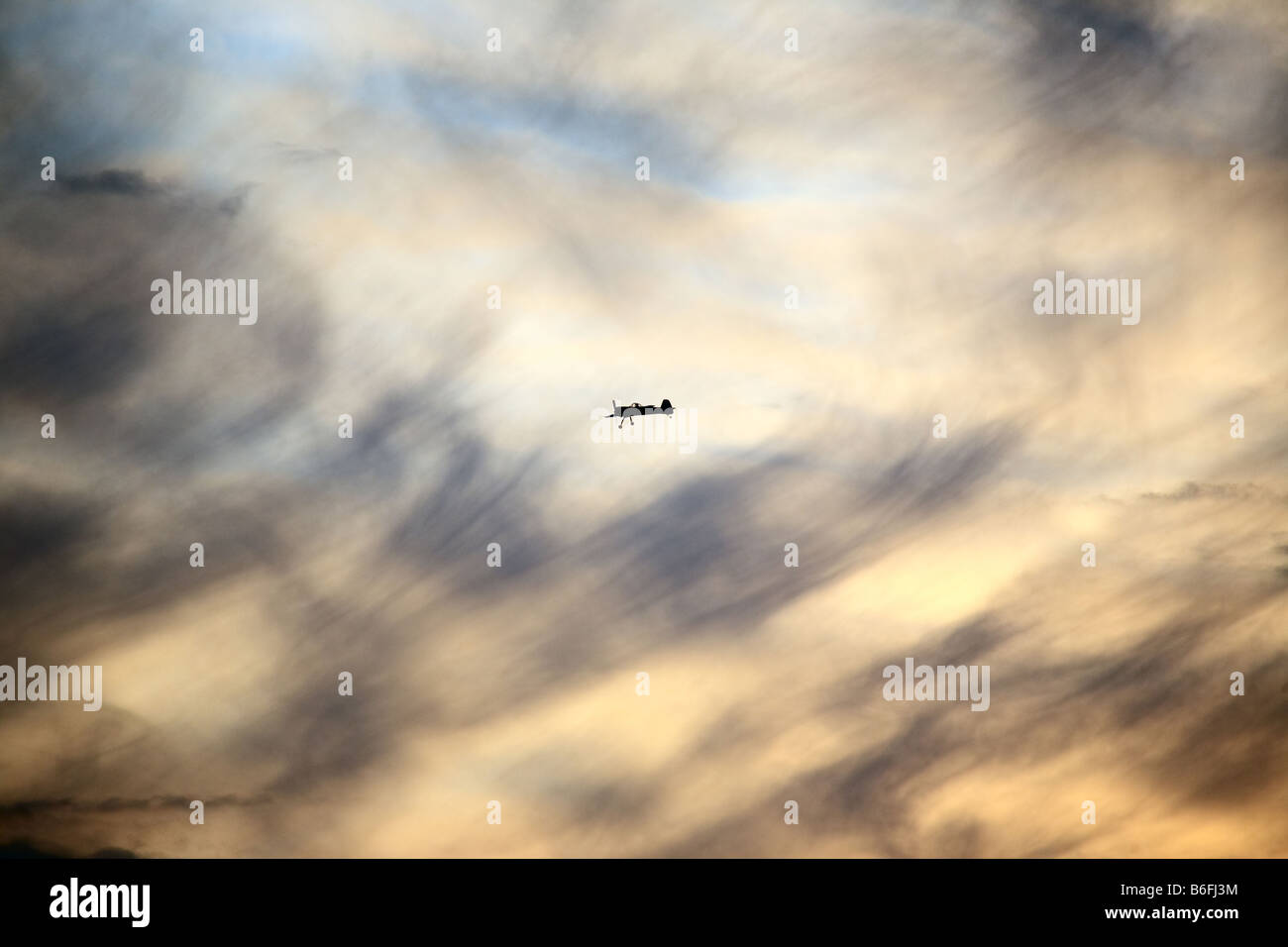 Plane at dramatic evening sky background Stock Photo - Alamy