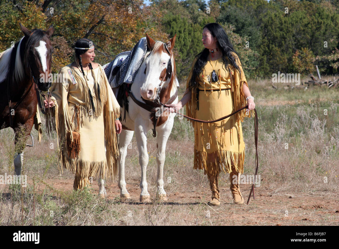 Two Native American Indian women walking their horses enjoying the day ...