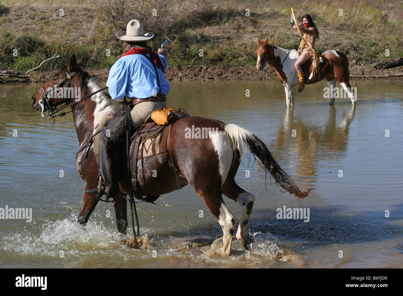 A cowboy and Native American face off across a body of water Stock ...