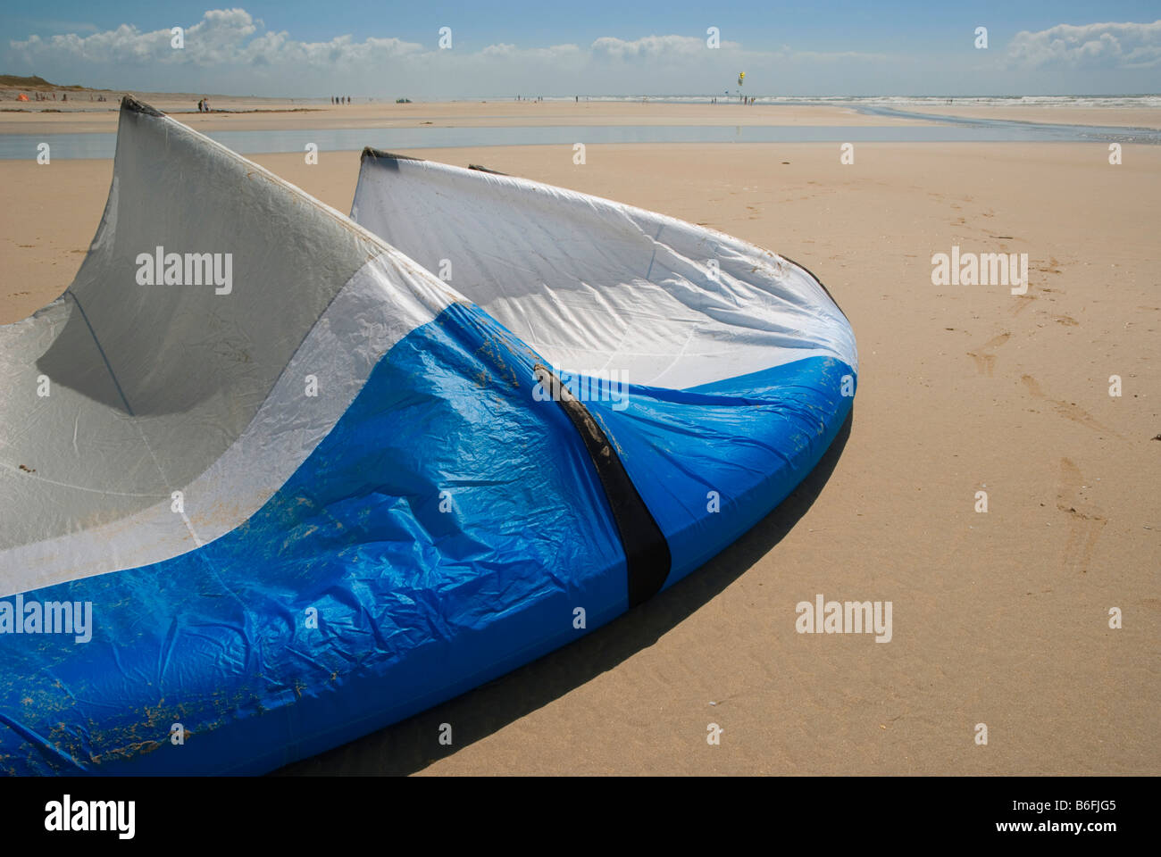 Kite sail lying on the sand of a beach in Brittany, France, Europe ...