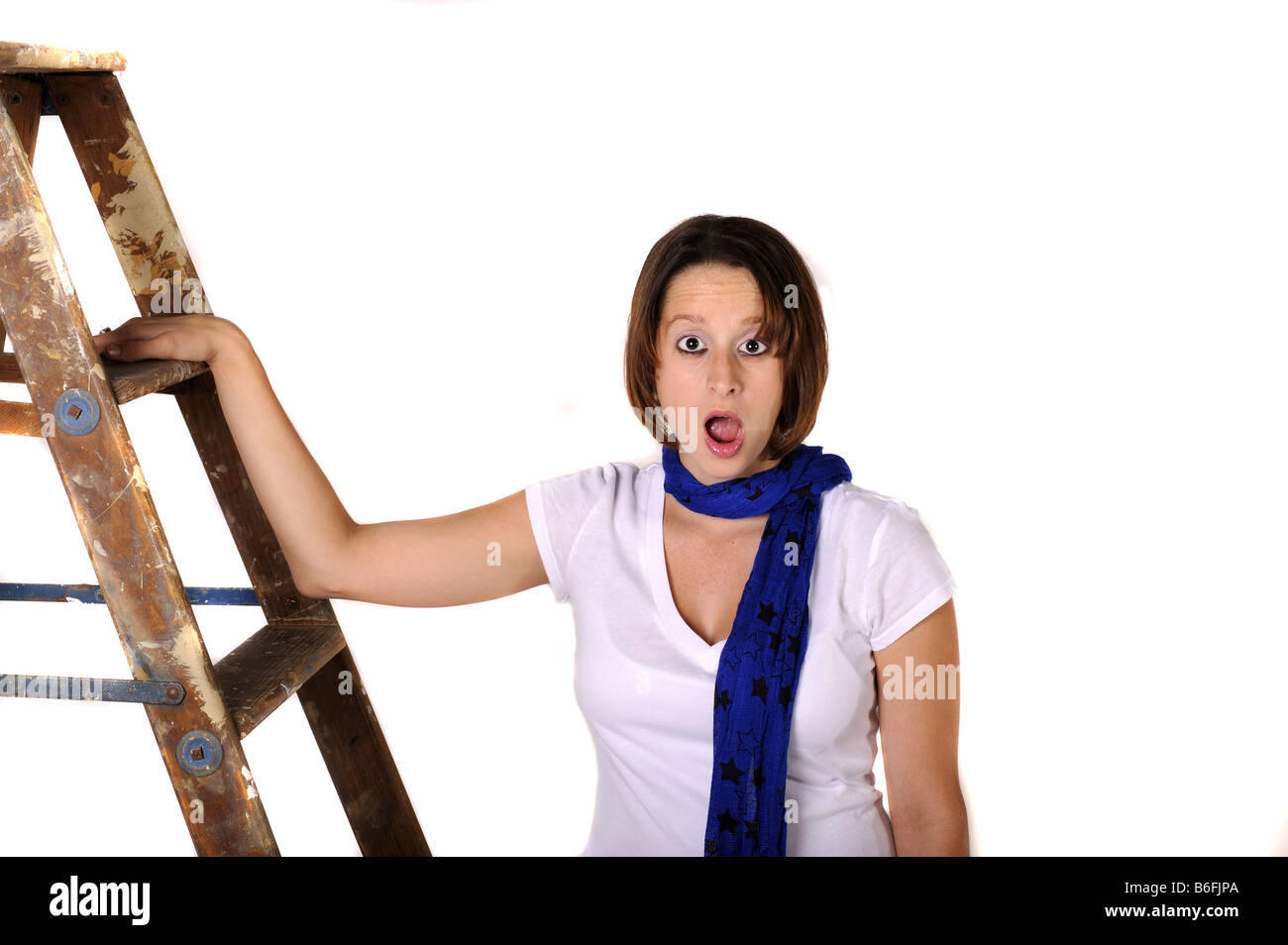 Teen girl with ladder making face Stock Photo - Alamy