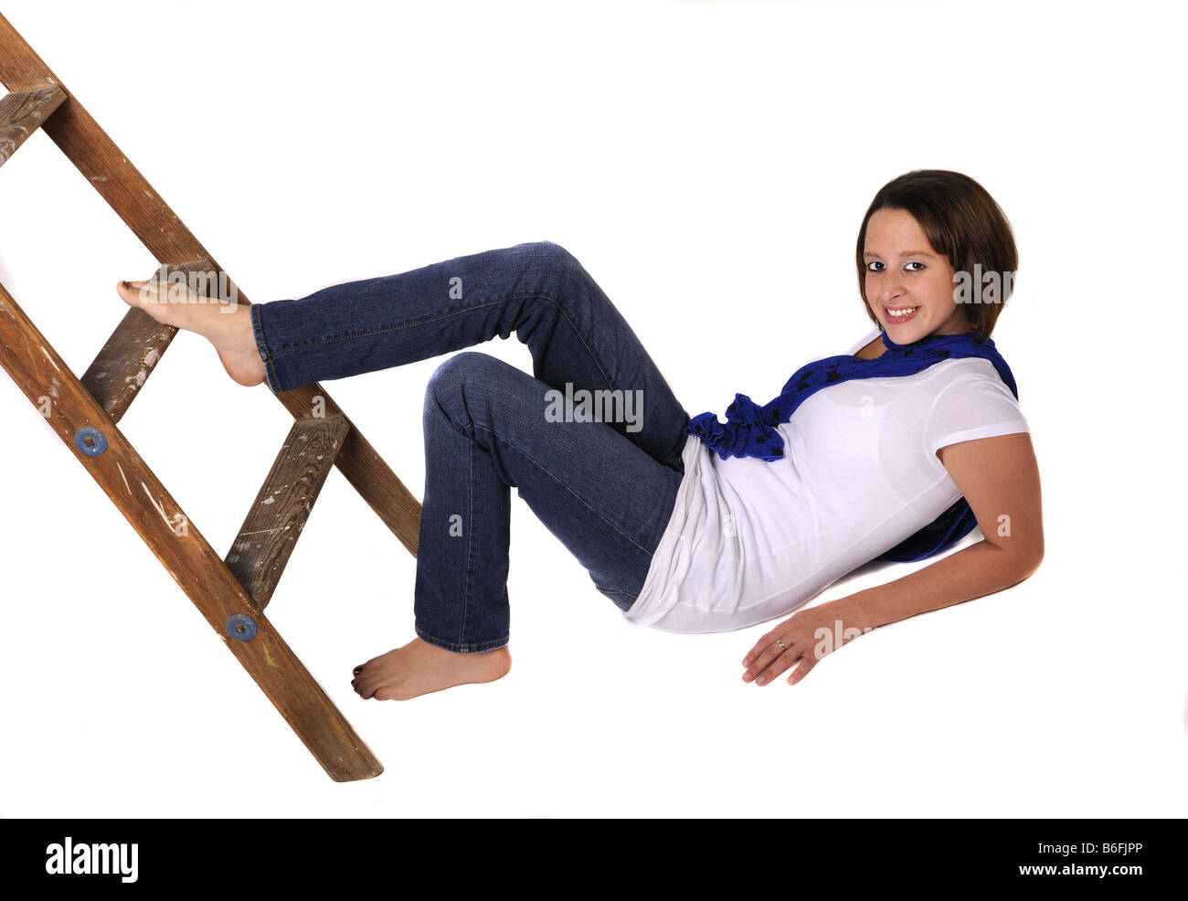 Teen girl and ladder in studio Stock Photo - Alamy