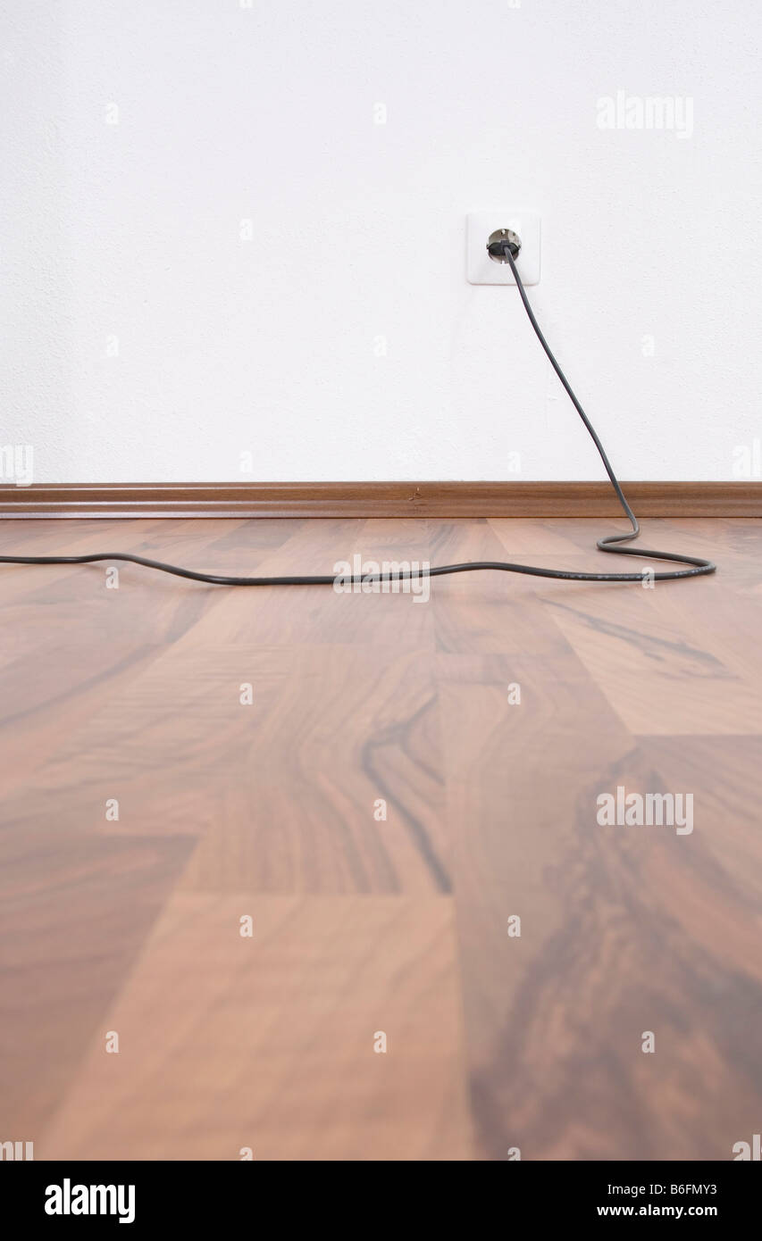 Cable in a wall socket Stock Photo - Alamy
