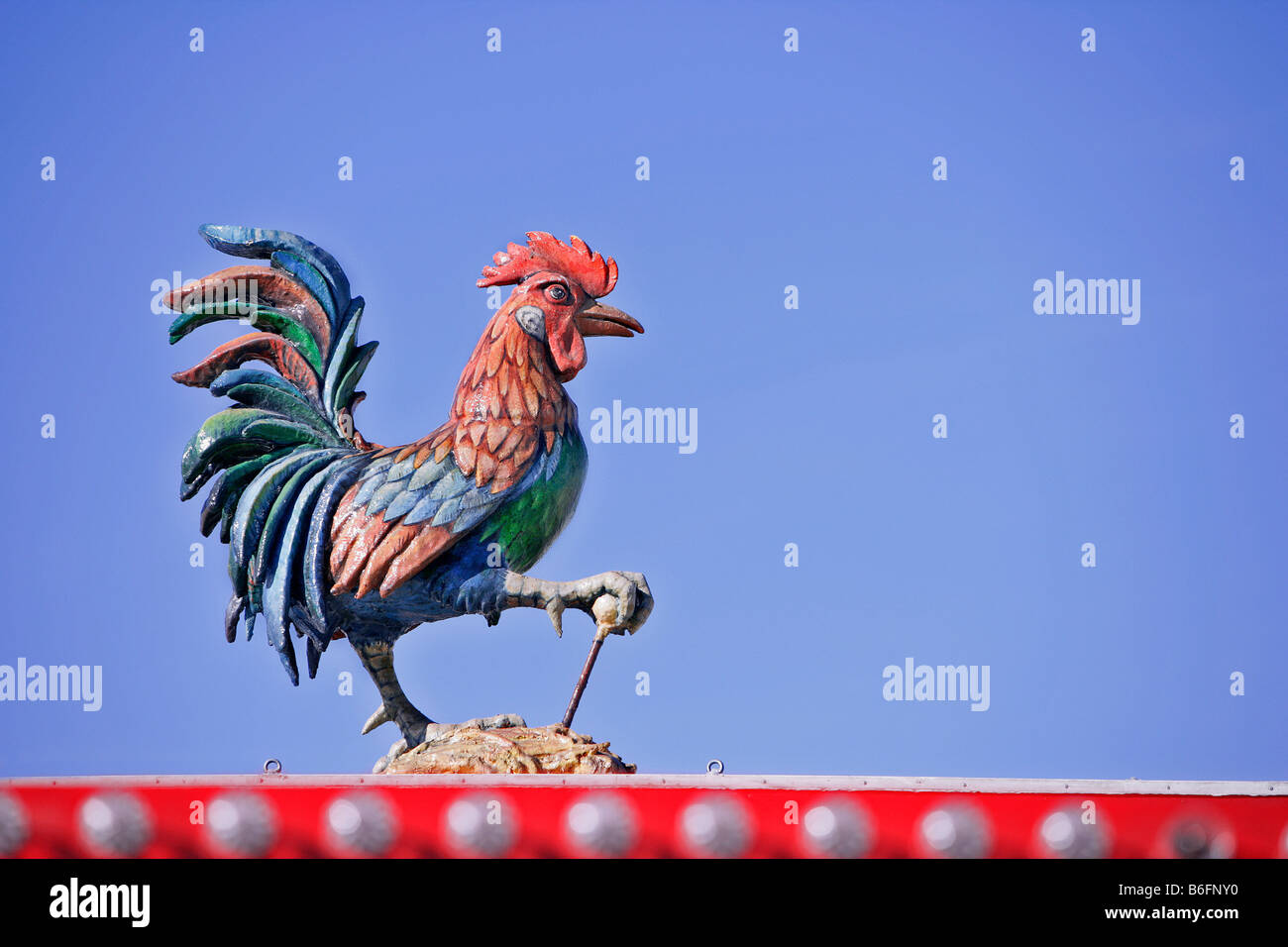 Coloured rooster on the roof of a chicken rotisserie Stock Photo - Alamy
