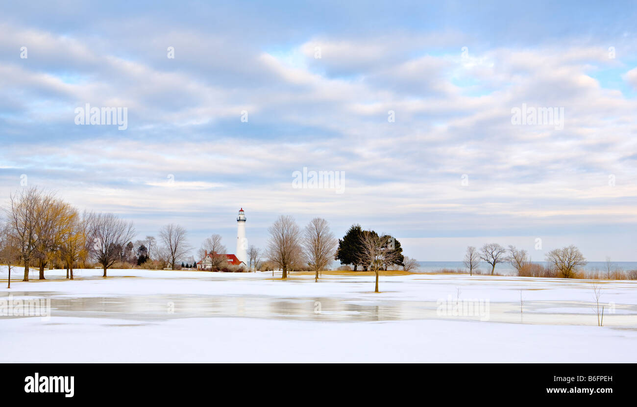 The Racine lighthouse is reflected in a pool of ice at Shoop Park, the ...