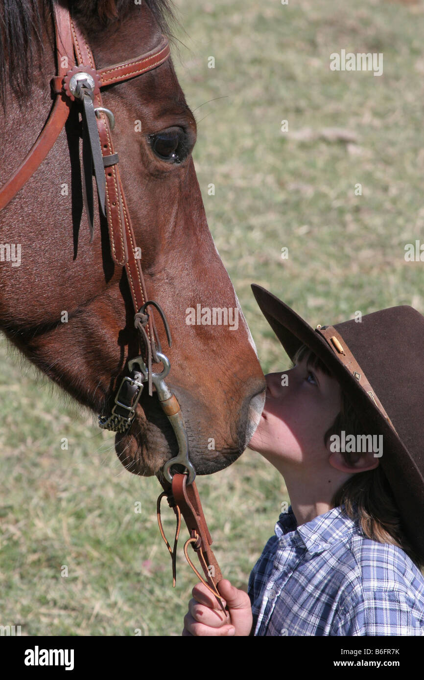 A young cowboy kissing his horse on the ranch Stock Photo - Alamy