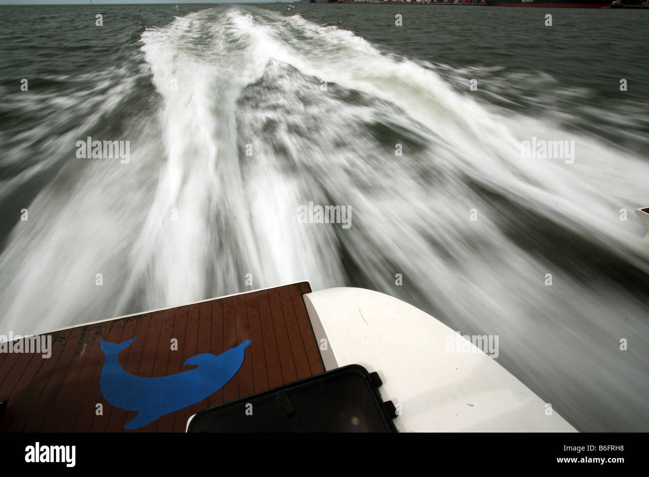 RUSHING WATER BEING PROPELLED FROM THE REAR OF A JET BOAT HORIZONTAL ...
