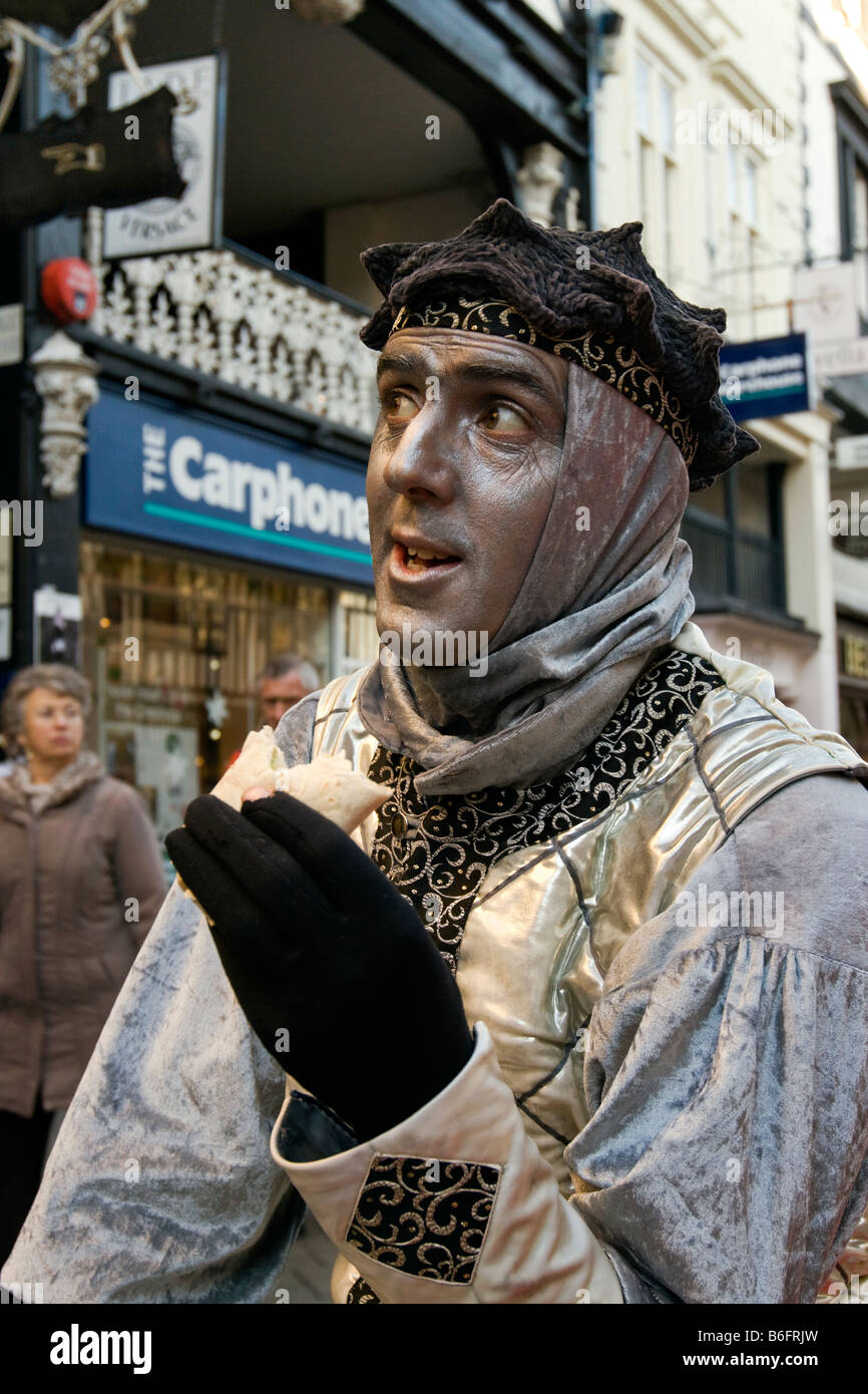 UK Cheshire Chester city centre at Christmas the silver man mime artist ...