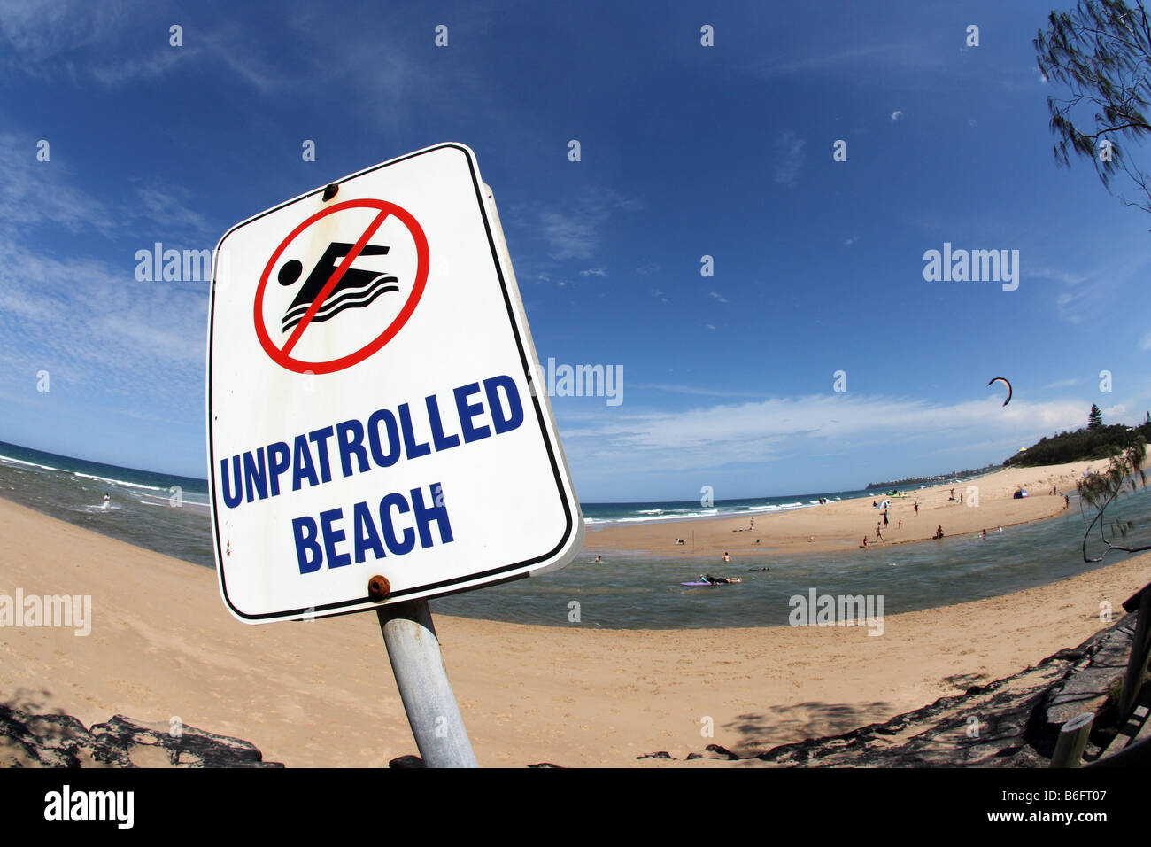 UNPATROLLED BEACH WARNING SIGN BLUE SKY BACKGROUND HORIZONTAL L ...