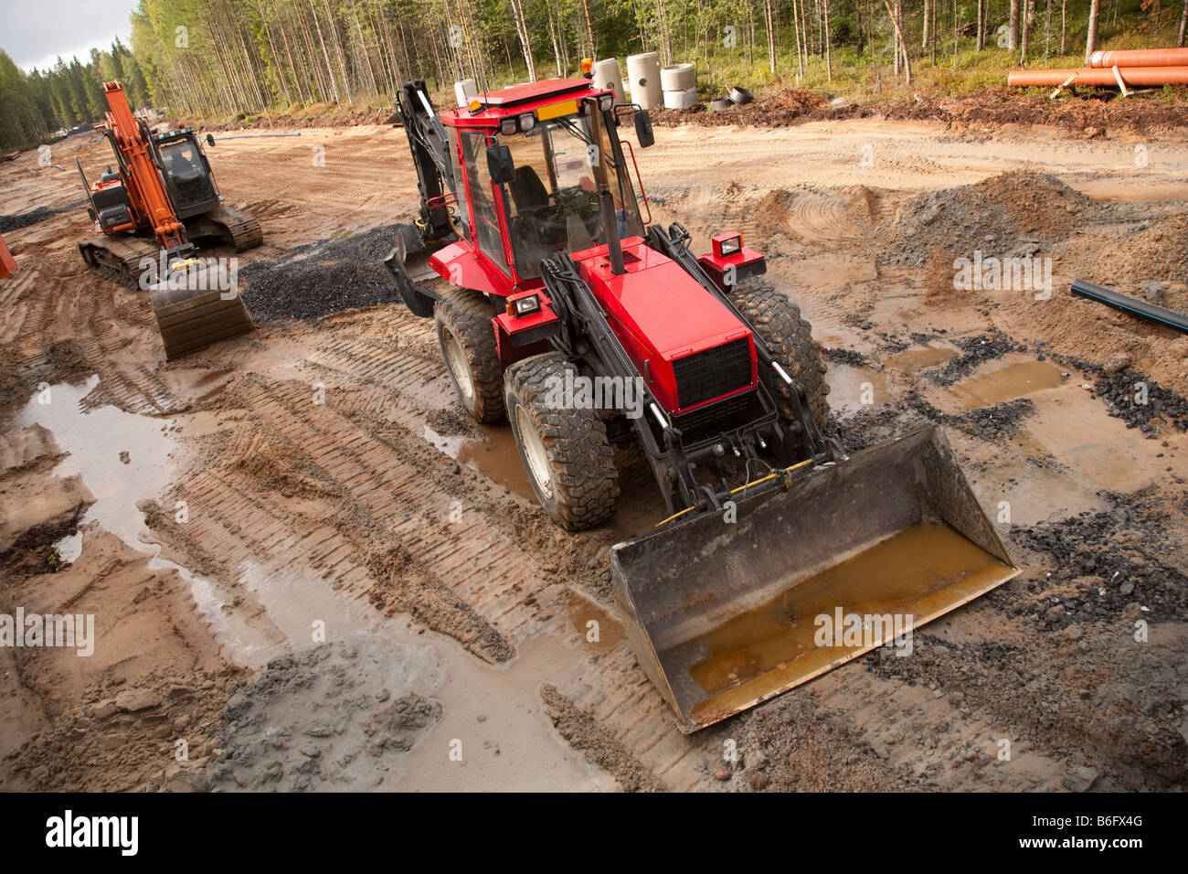 Tractor and digger at roadworks site , Finland Stock Photo - Alamy