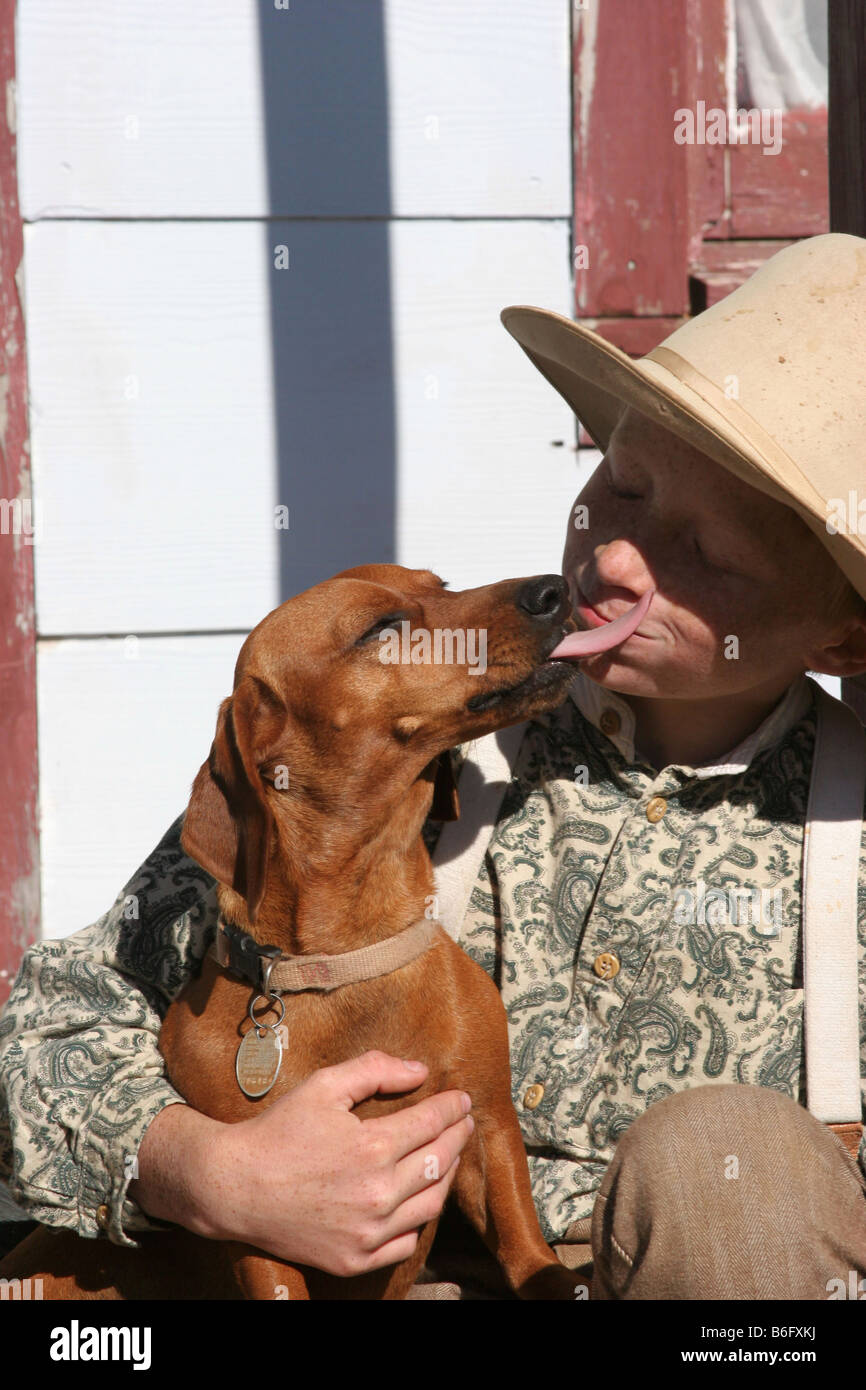 Puppy love A boy is receiving a kiss from a dog Stock Photo - Alamy