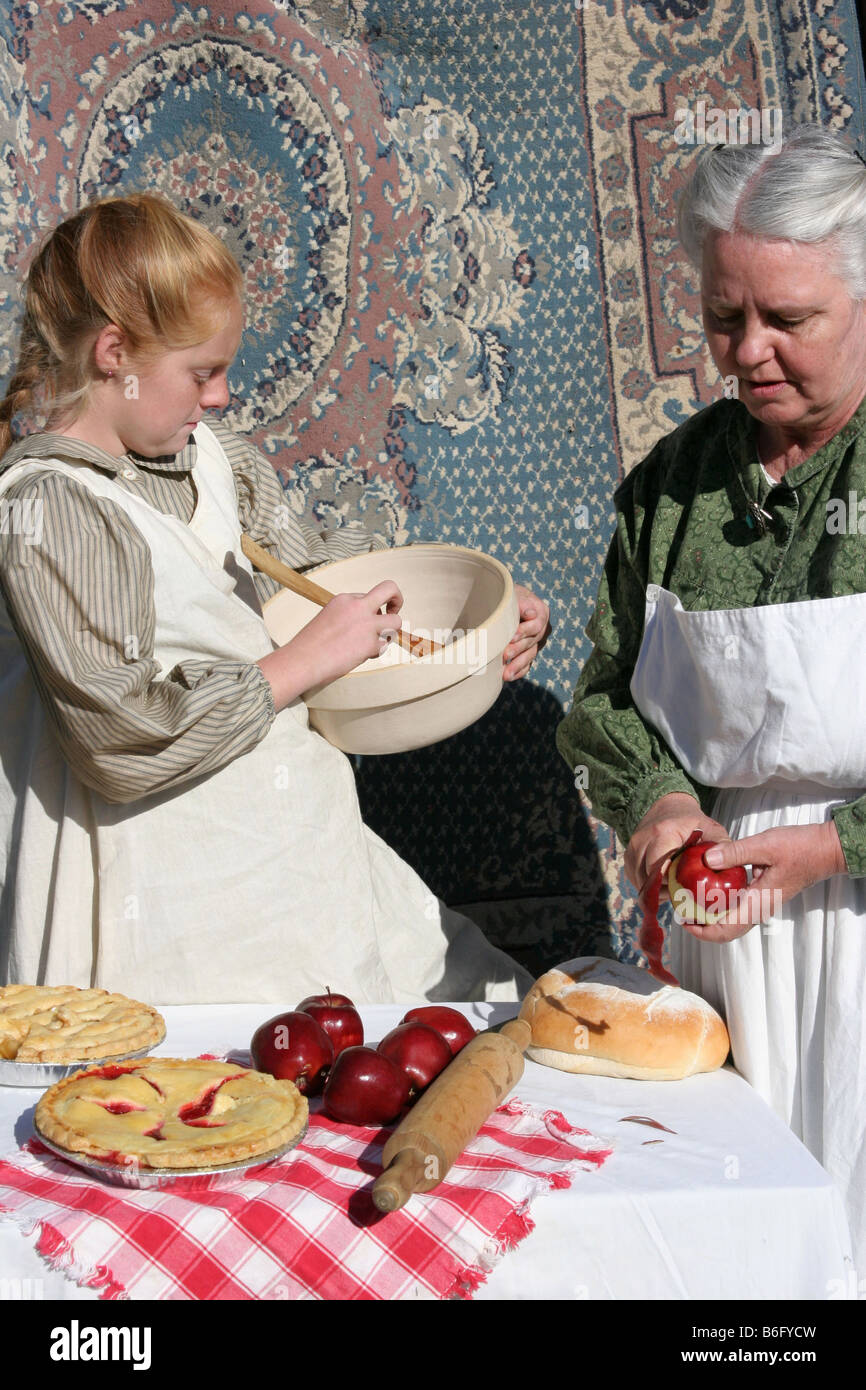 A mother daughter team baking an apple pie together outside Stock Photo ...