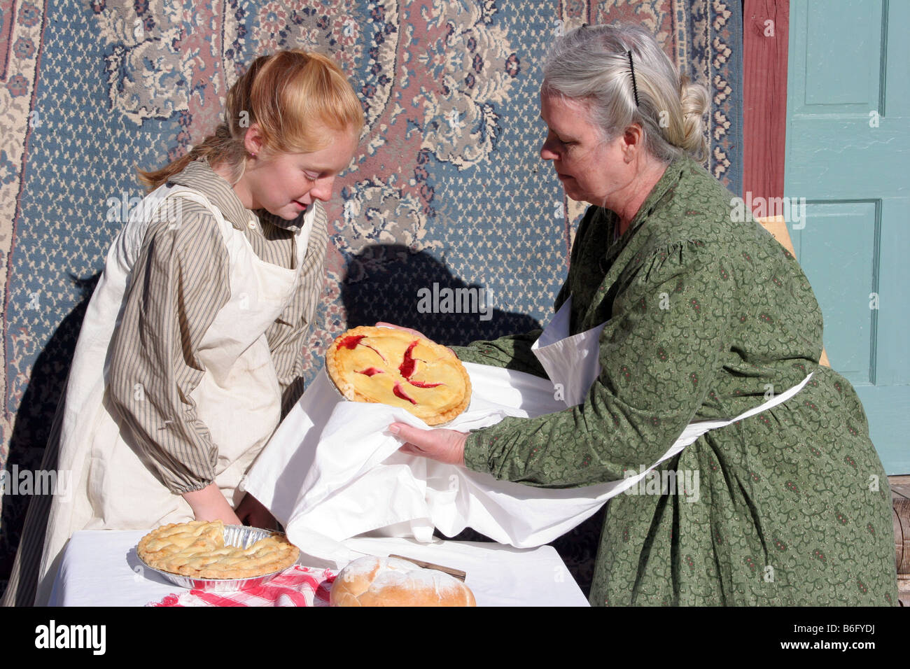 Mother and daughter baking a cherry pie together in the country Stock ...