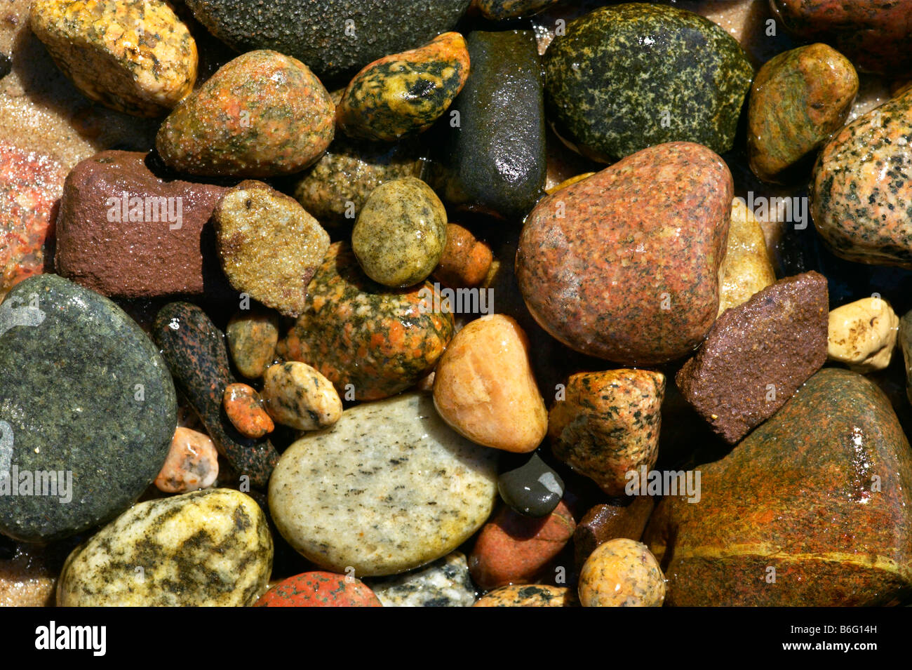 Wet colored rocks for use as a background Stock Photo - Alamy