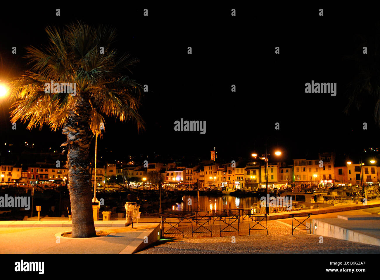 Illuminated palm tree in harbour, french village, Cassis, Provence ...