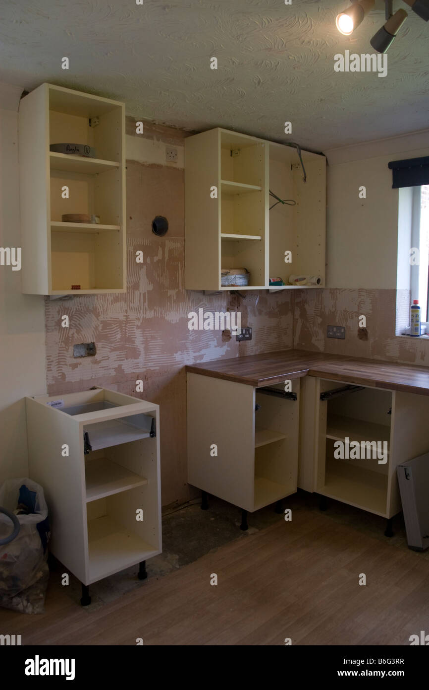 New Kitchen being installed in Modern British House Stock Photo - Alamy