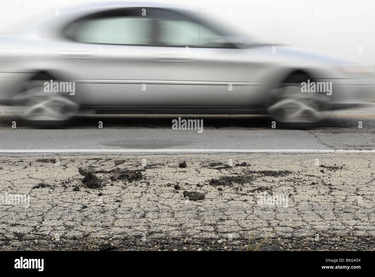 A car on a deteriorating road Stock Photo - Alamy