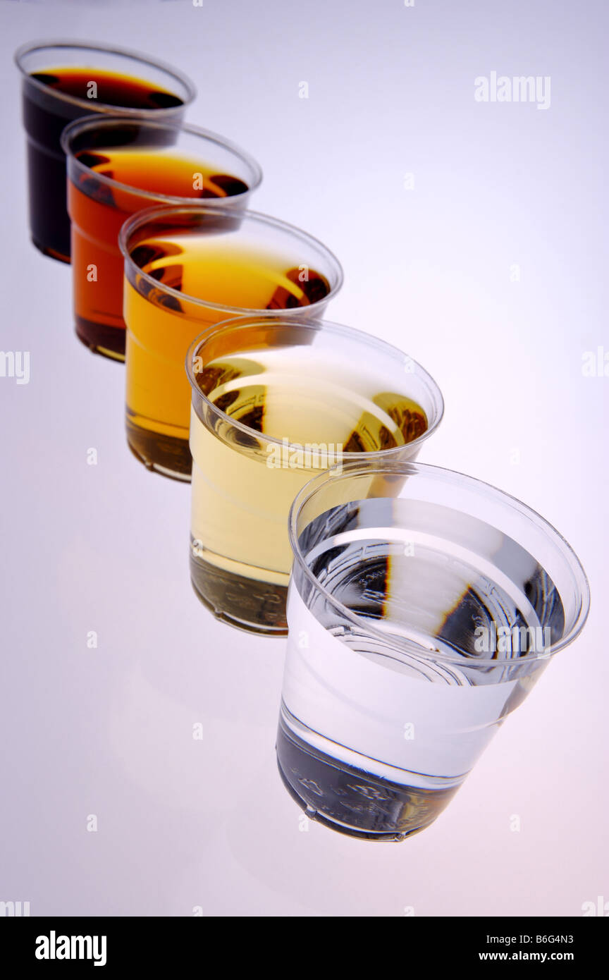 Full transparent plastic cups in a row Stock Photo - Alamy