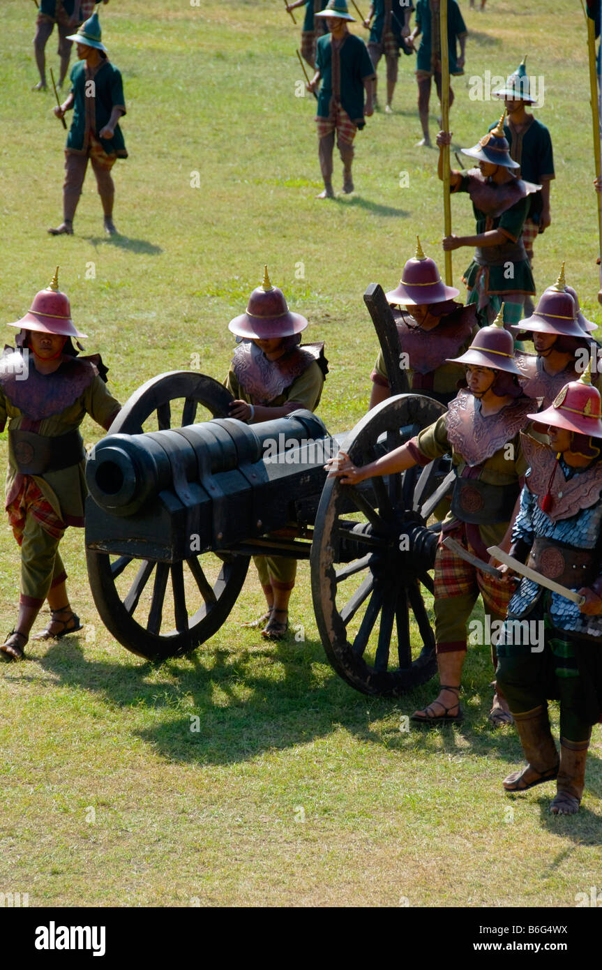firing the cannon during a mock battle at the Surin Elephant Festival ...