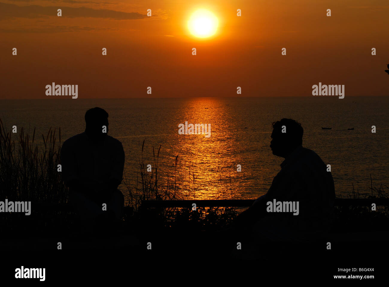 sunset and two persons Stock Photo - Alamy