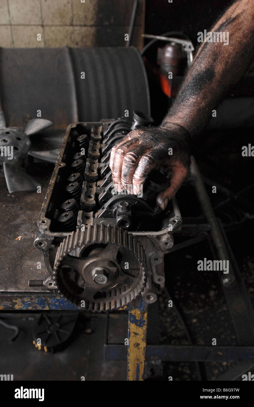 mechanic fixing a motor in a workshop Stock Photo - Alamy
