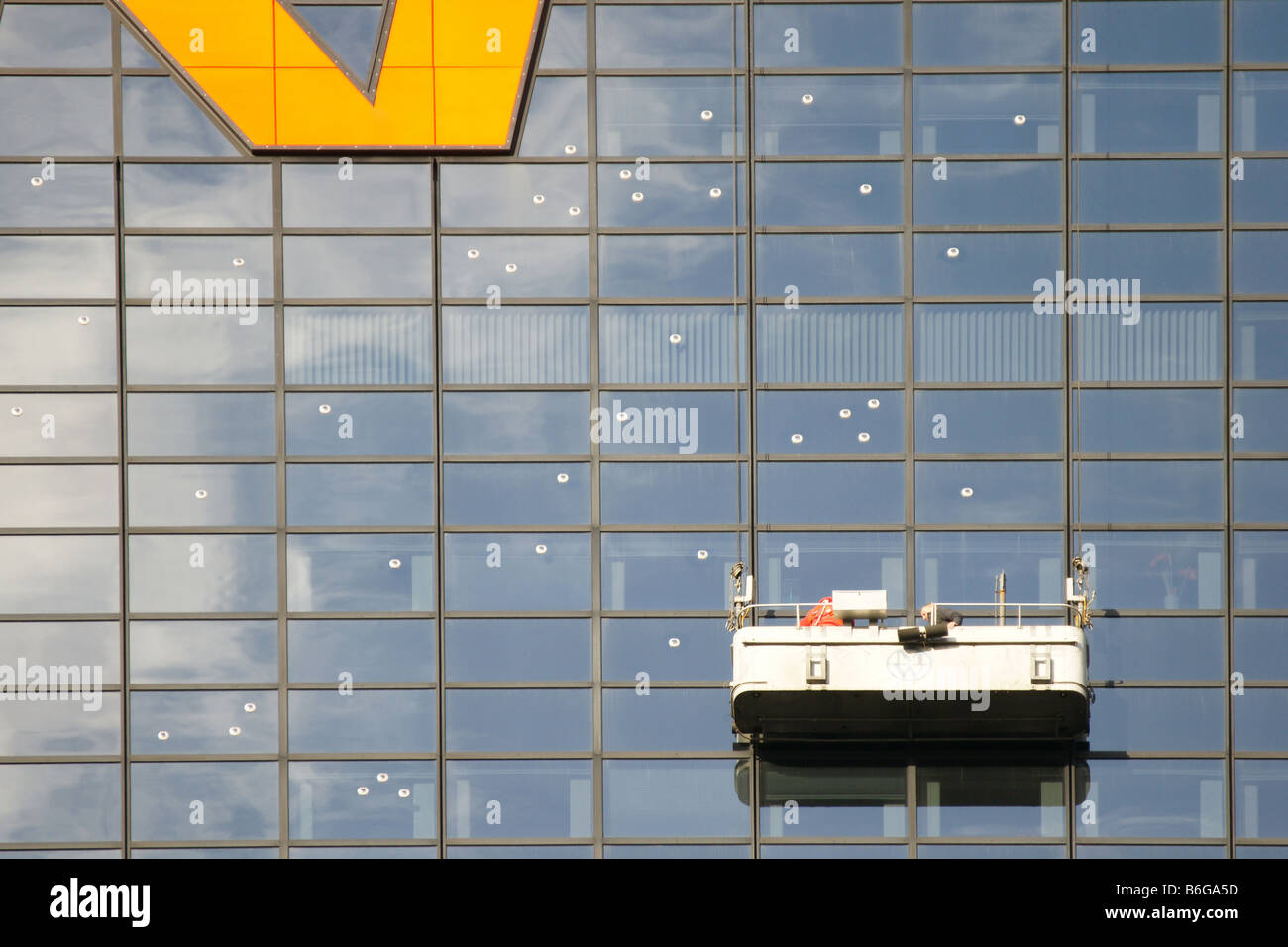 Cleaning glass facade windows bank building on suspension platform ...