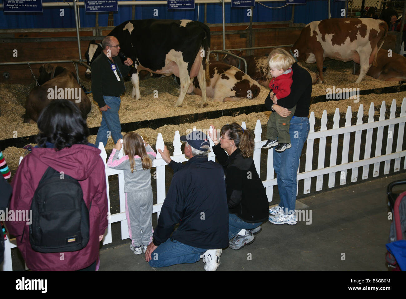 A crowd of people are viewing Holstein Cow on display at Agricultural ...