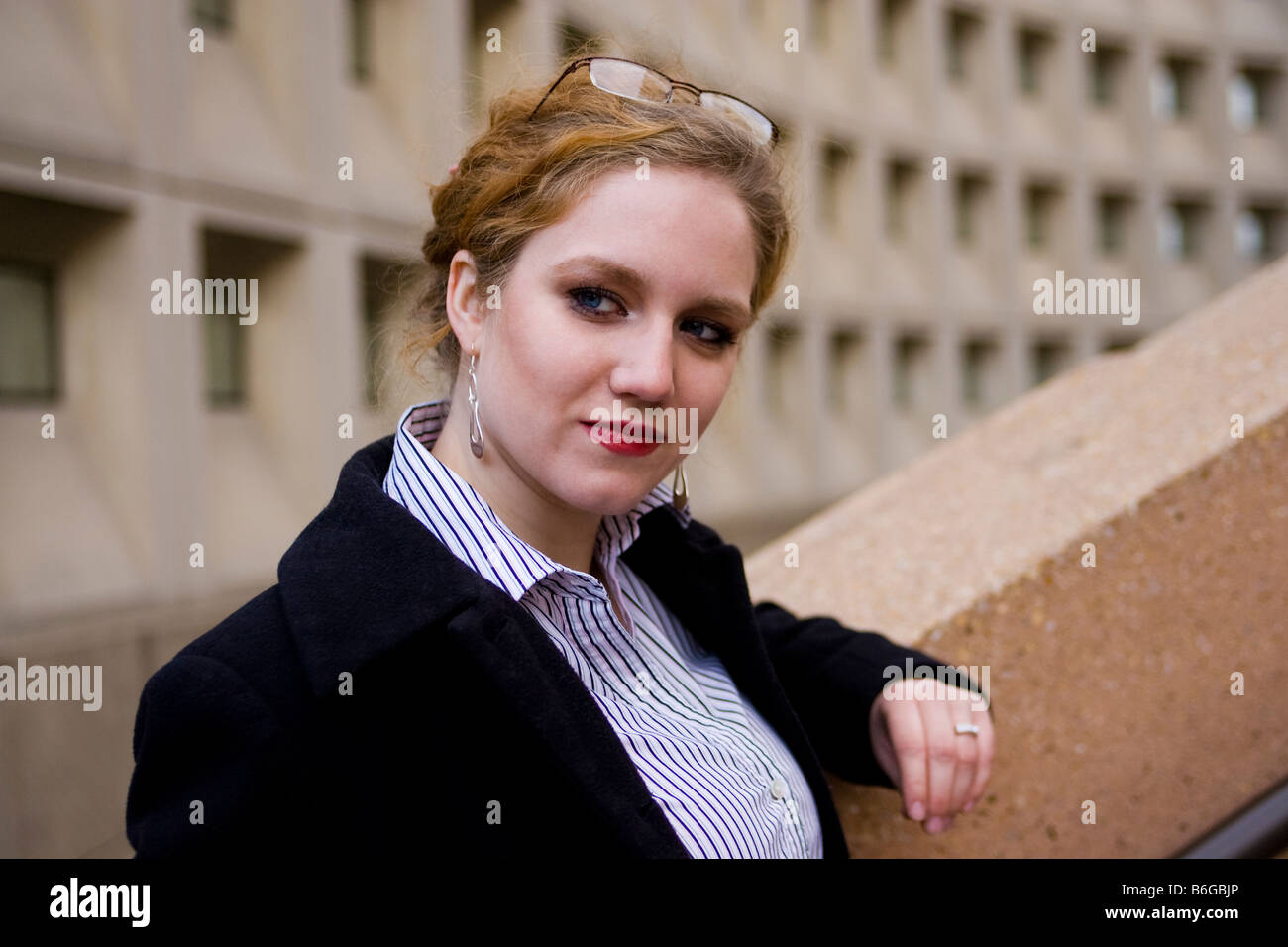 Caucasian business woman standing next to office building Stock Photo ...