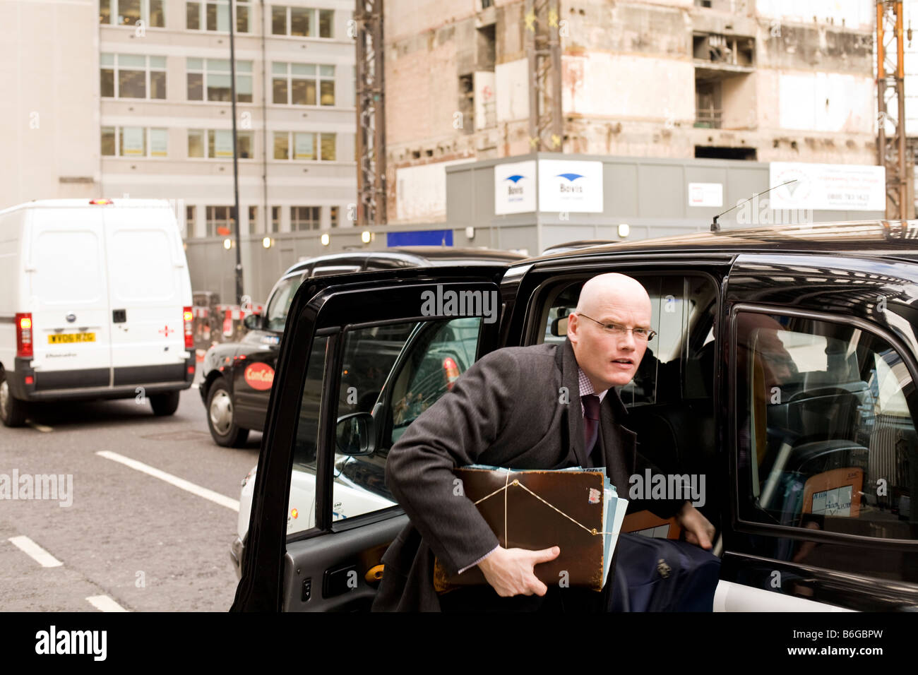 man getting into taxi in London Stock Photo - Alamy
