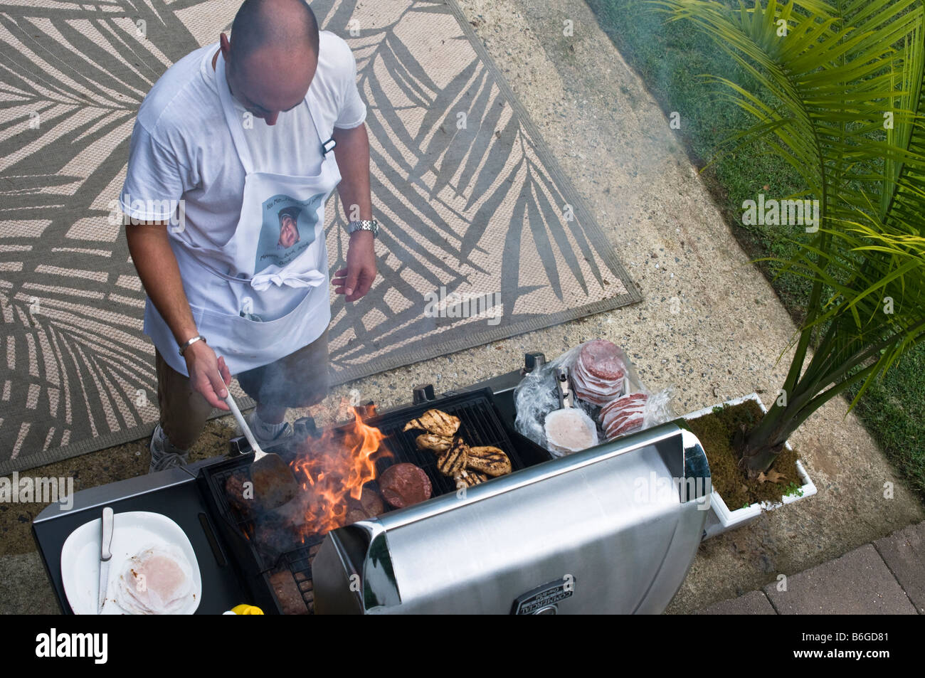 Family reunion get together. Grilling hamburgers, hot dogs, chicken and ...